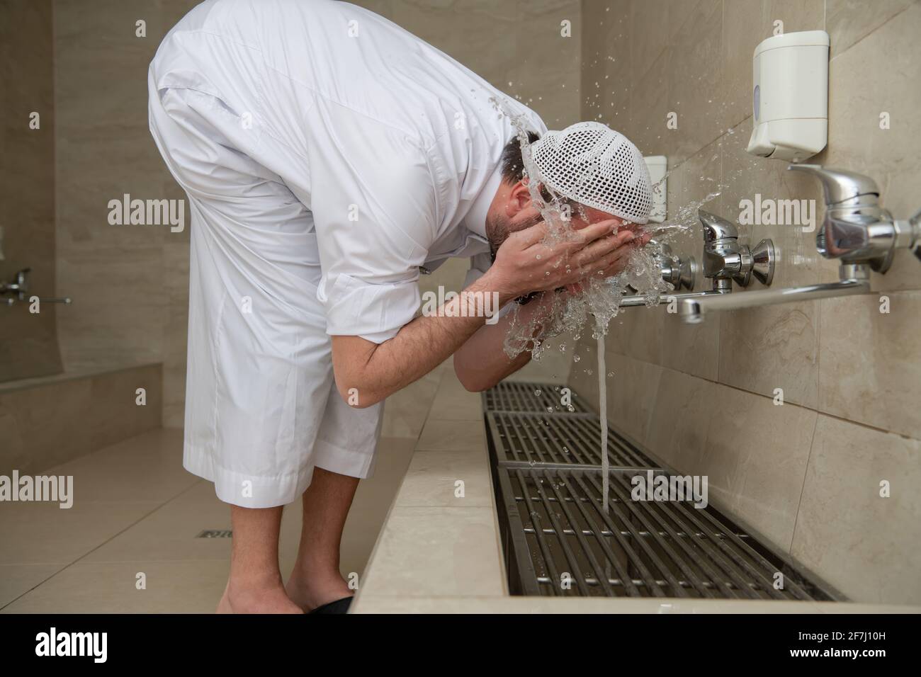 A Muslim takes ablution for prayer. Islamic religious rite Stock Photo ...