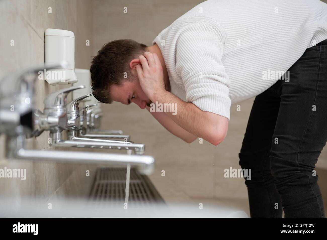 A Muslim takes ablution for prayer. Islamic religious rite Stock Photo ...