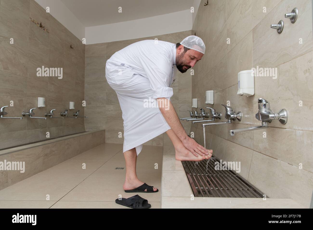 A Muslim takes ablution for prayer. Islamic religious rite Stock Photo ...
