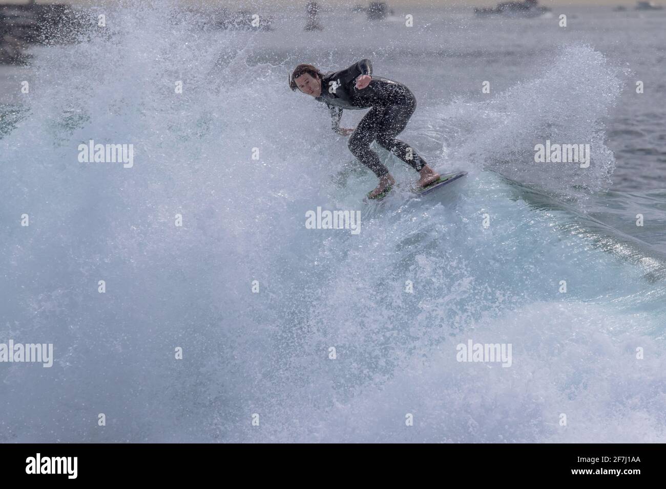 Skimboarder surfing and performing tricks at the Wedge Newport Beach ...