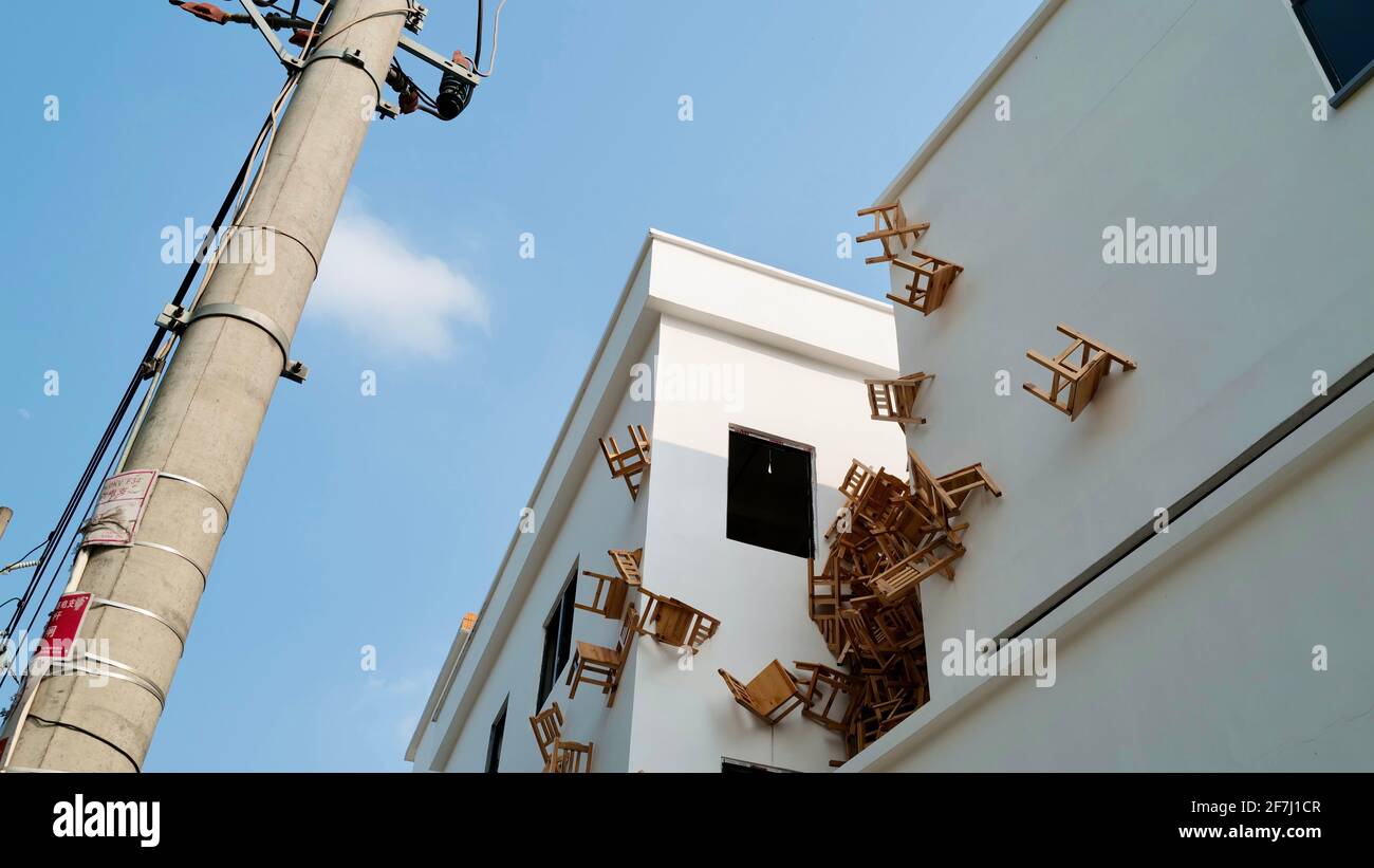 A special designed architecture with lots of wooden chairs laying ...