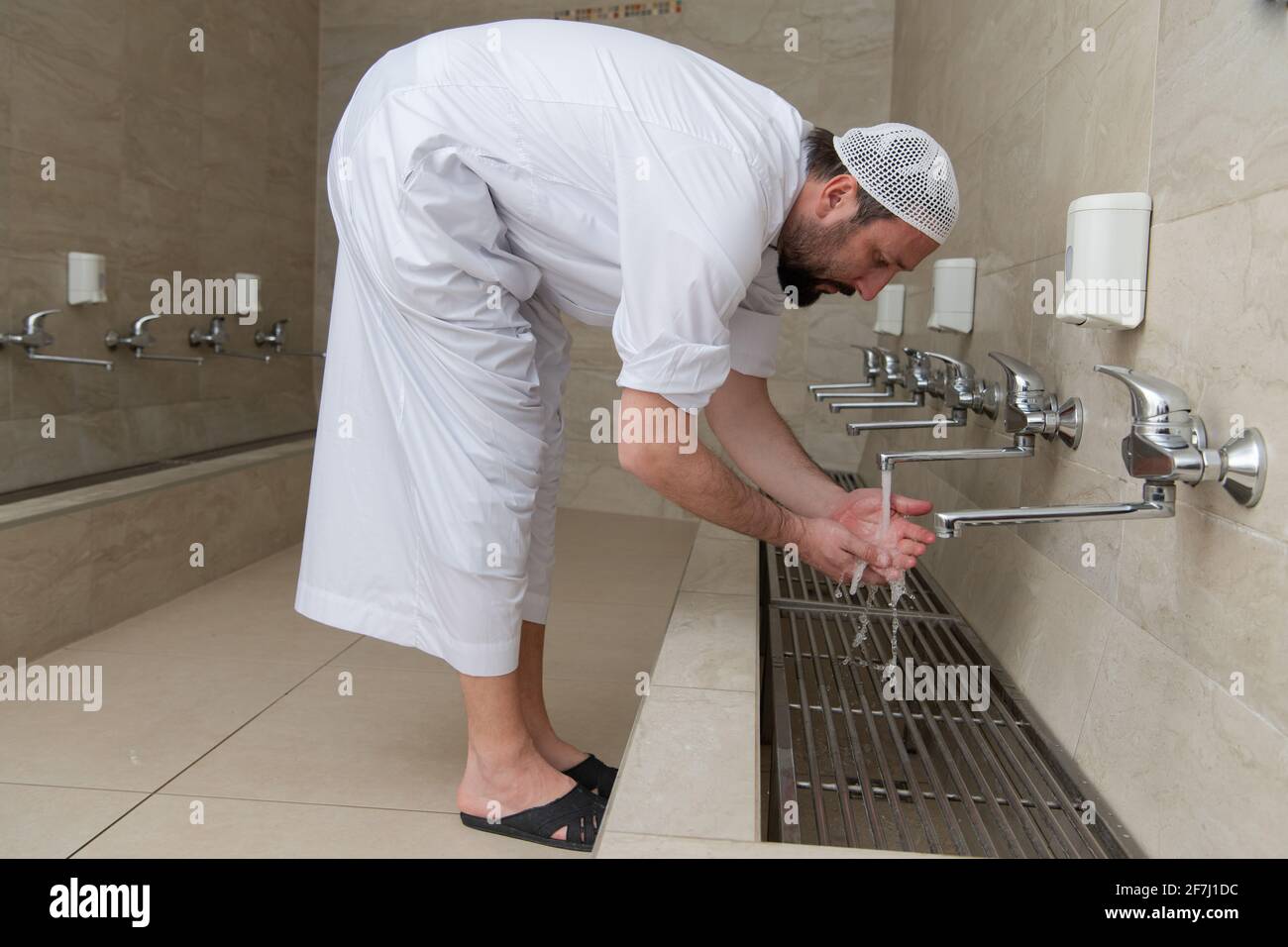 A Muslim takes ablution for prayer. Islamic religious rite Stock Photo ...