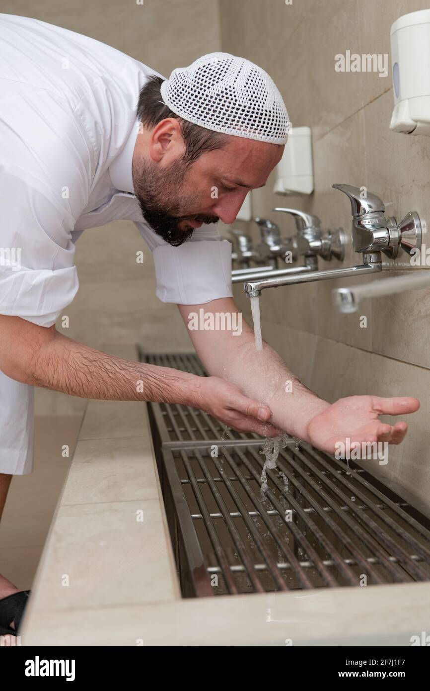 A Muslim takes ablution for prayer. Islamic religious rite Stock Photo ...
