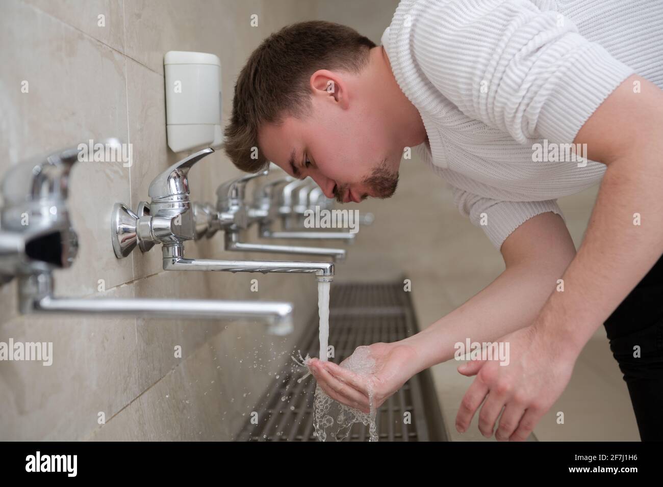 A Muslim takes ablution for prayer. Islamic religious rite Stock Photo ...