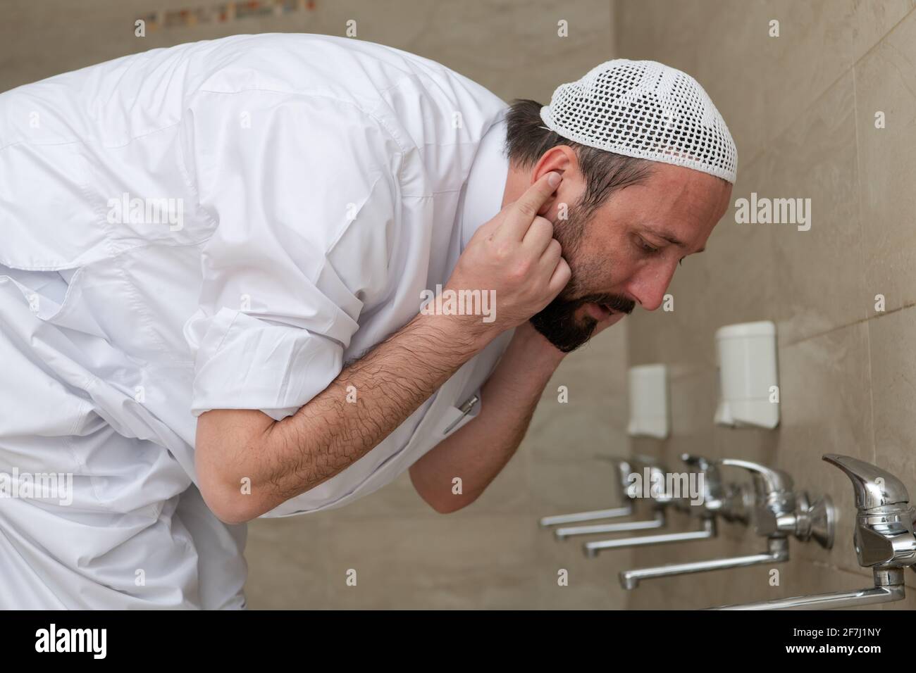 A Muslim takes ablution for prayer. Islamic religious rite Stock Photo ...