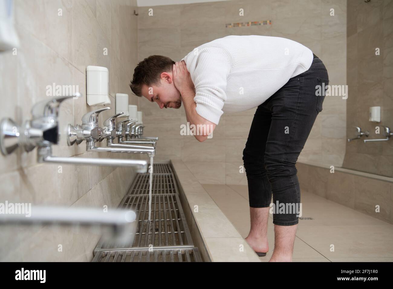 A Muslim takes ablution for prayer. Islamic religious rite Stock Photo ...