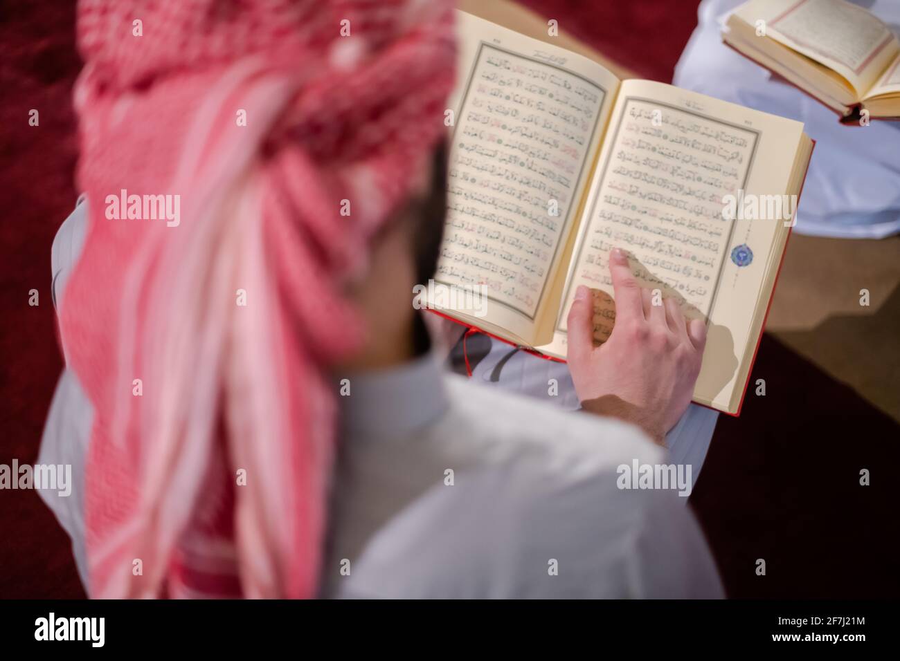 two muslim people in mosque reading quran together concept of islamic ...