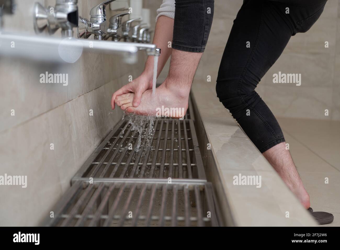 A Muslim takes ablution for prayer. Islamic religious rite Stock Photo ...