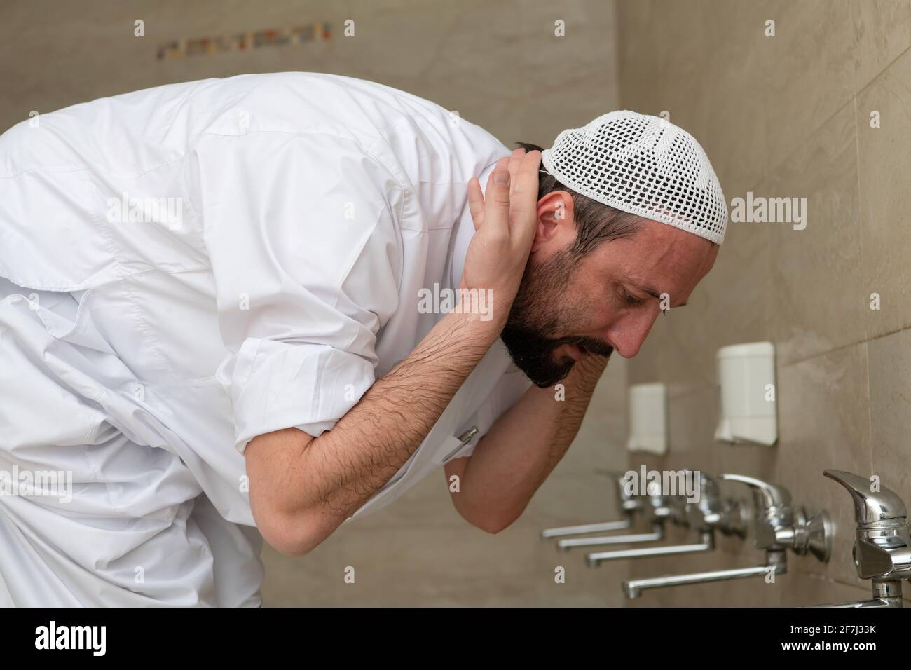 A Muslim takes ablution for prayer. Islamic religious rite Stock Photo ...