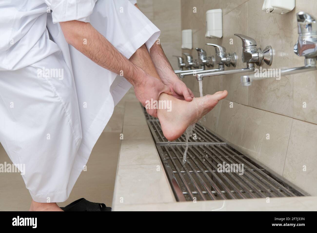 A Muslim takes ablution for prayer. Islamic religious rite Stock Photo ...