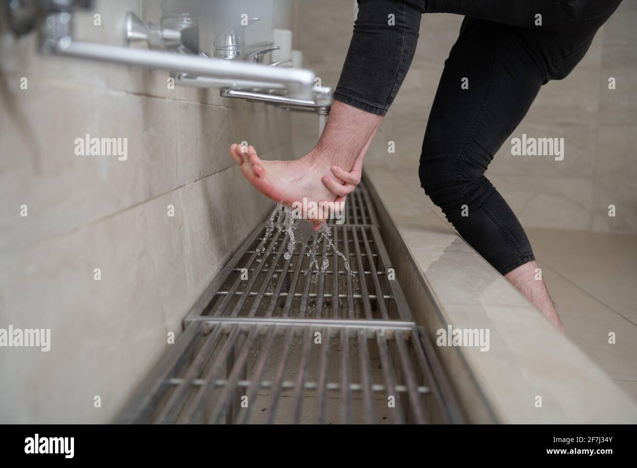A Muslim takes ablution for prayer. Islamic religious rite Stock Photo ...