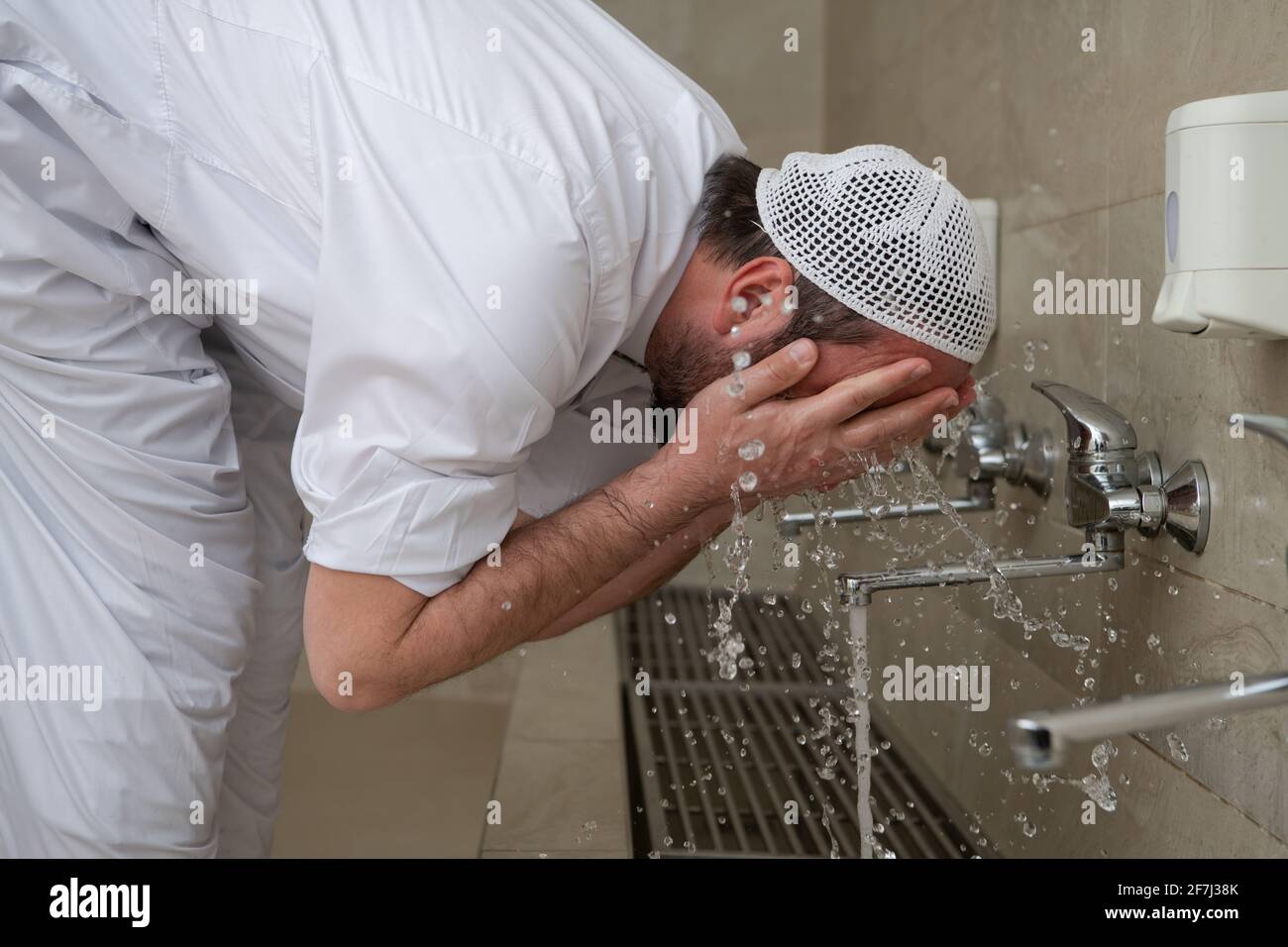 A Muslim takes ablution for prayer. Islamic religious rite Stock Photo ...