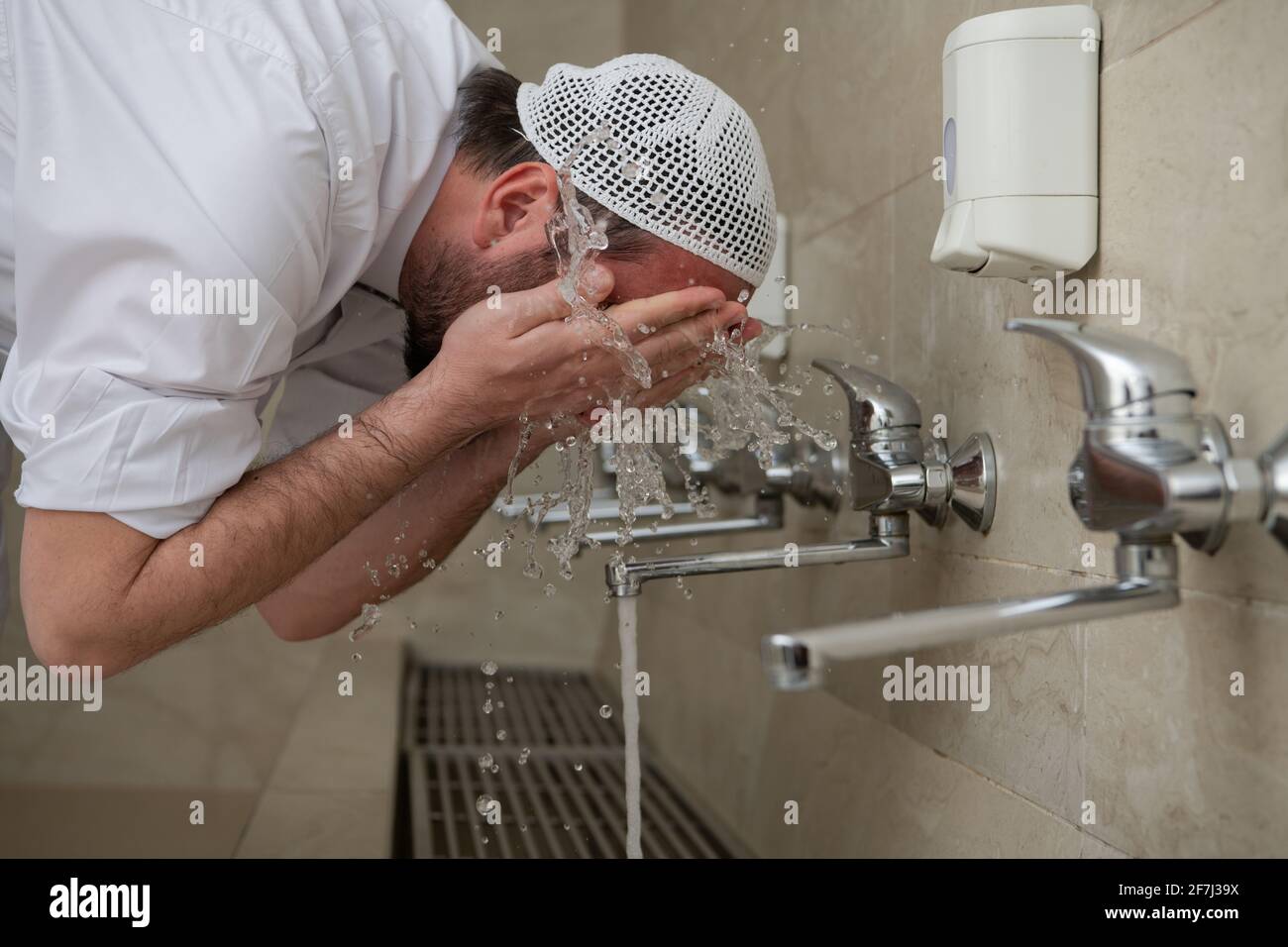 A Muslim takes ablution for prayer. Islamic religious rite Stock Photo ...