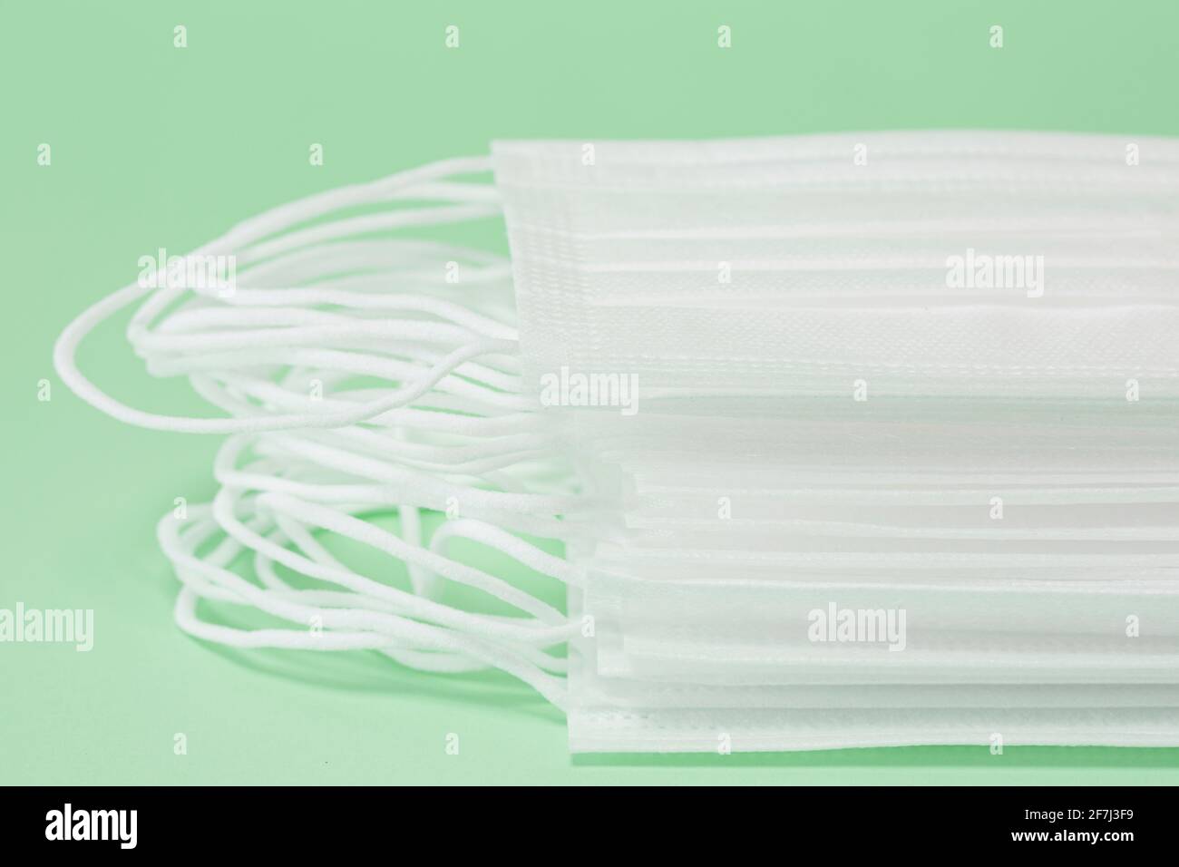 face mask, light green background Stock Photo - Alamy