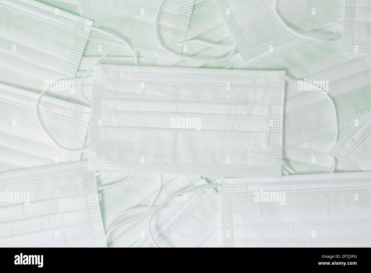 face mask, light green background Stock Photo - Alamy