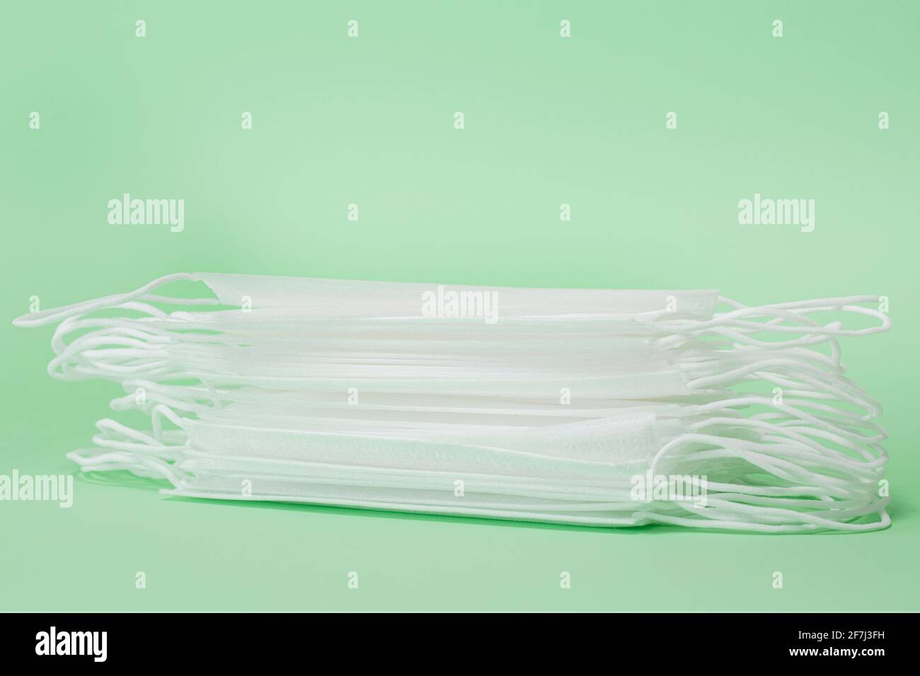 face mask, light green background Stock Photo - Alamy