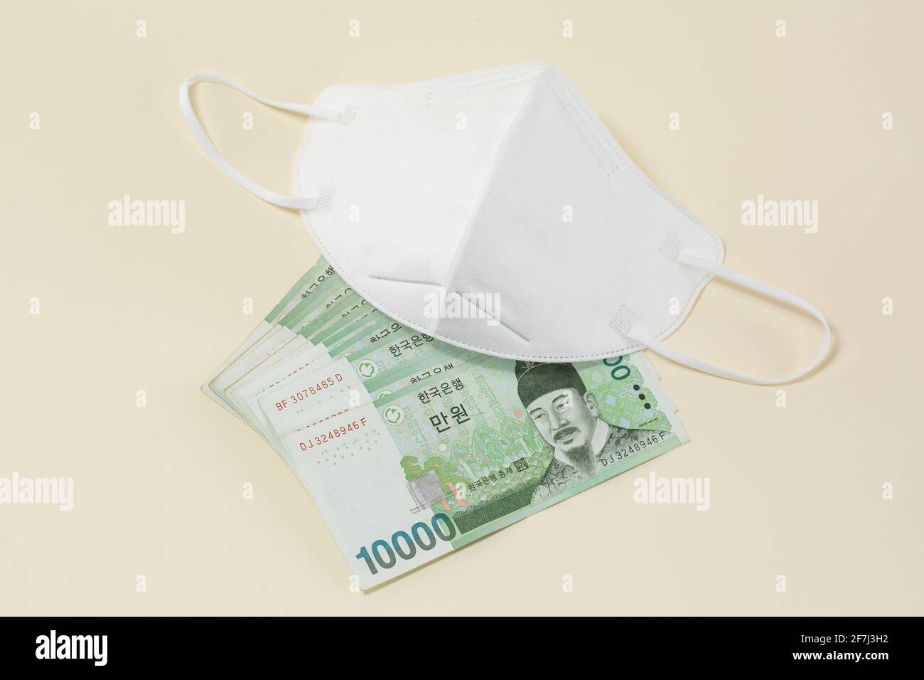 mask, money in yellow background Stock Photo - Alamy