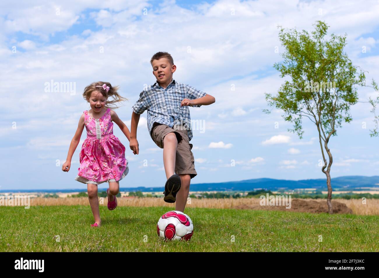 Girl playing soccer ball garden hi-res stock photography and images - Alamy