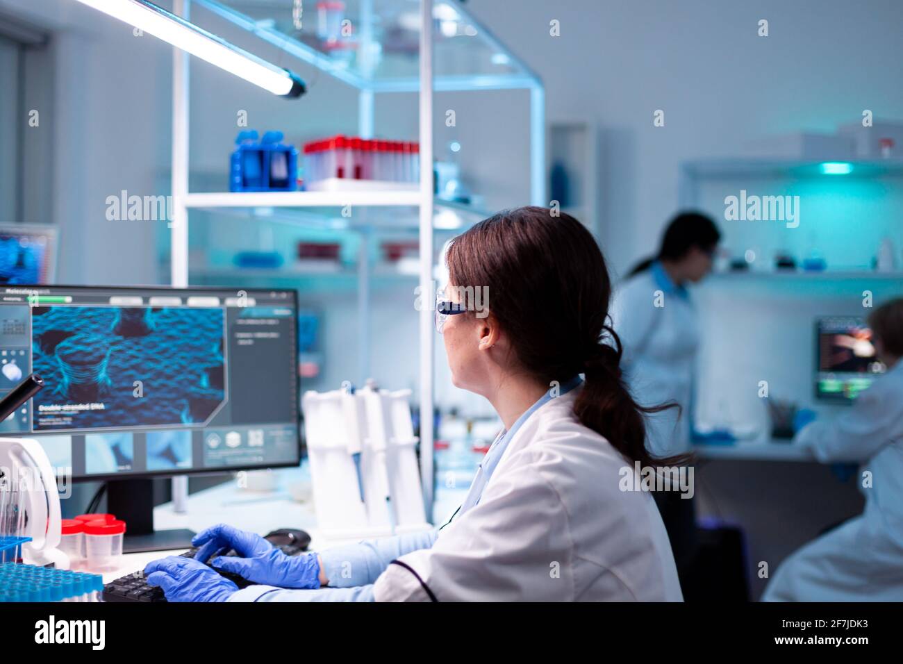 Specialist scientist pharmacology working on computer in hospital ...