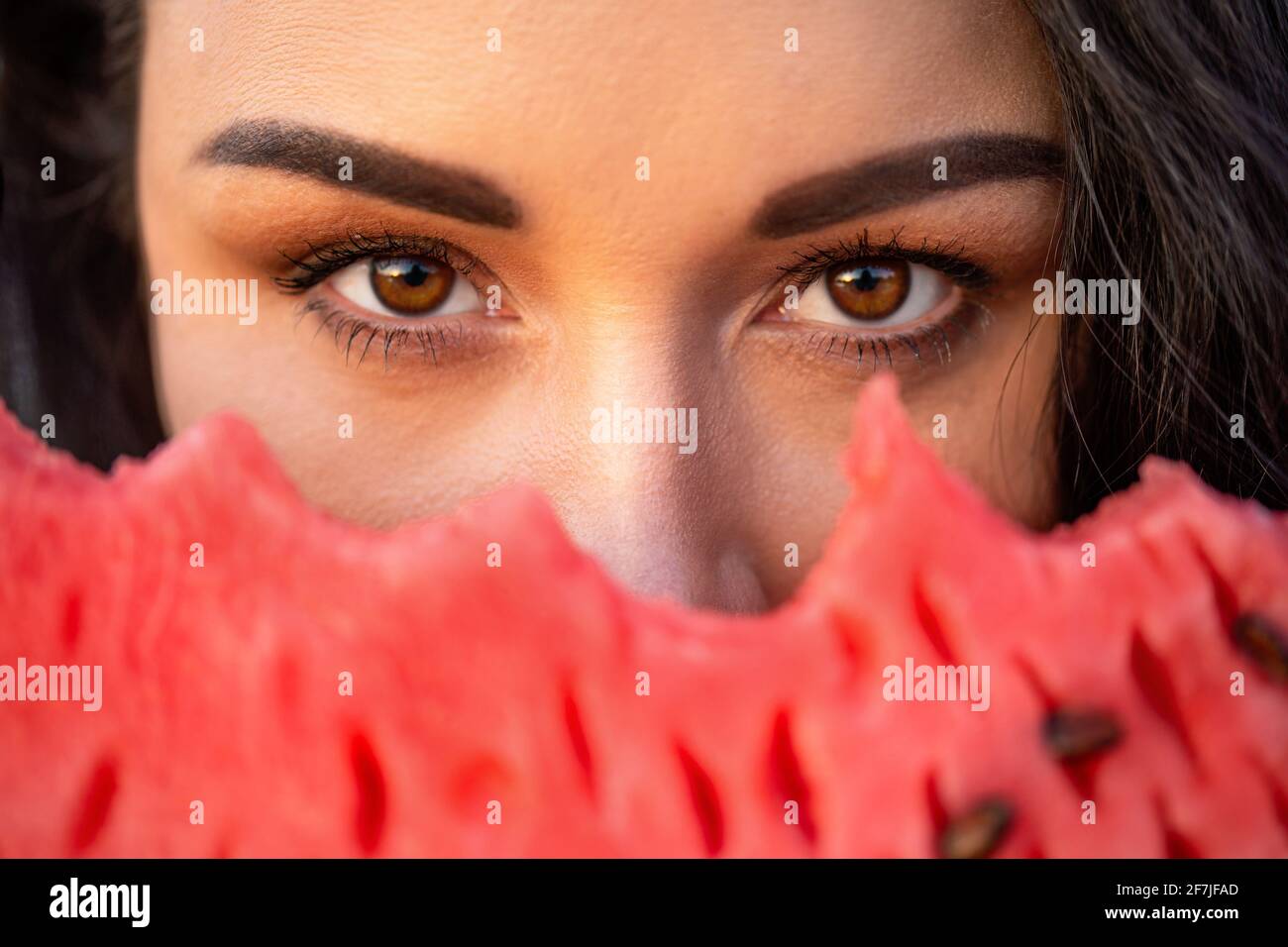 Watermelon near a woman's face. Close-up eyes portrait Stock Photo - Alamy