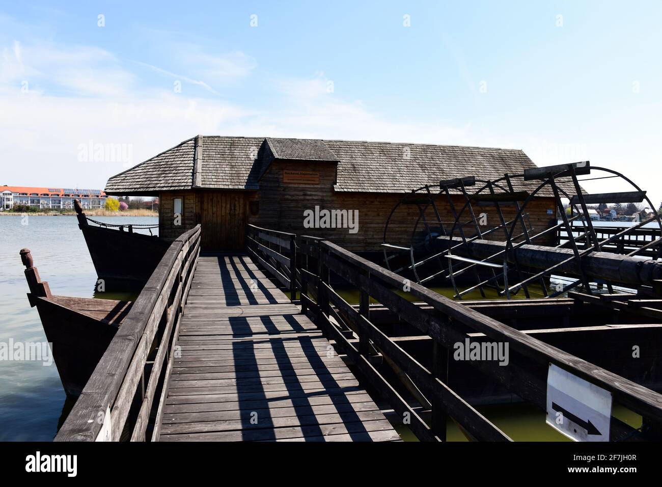 historic wooden floating boat mill. green river water. large boat house ...