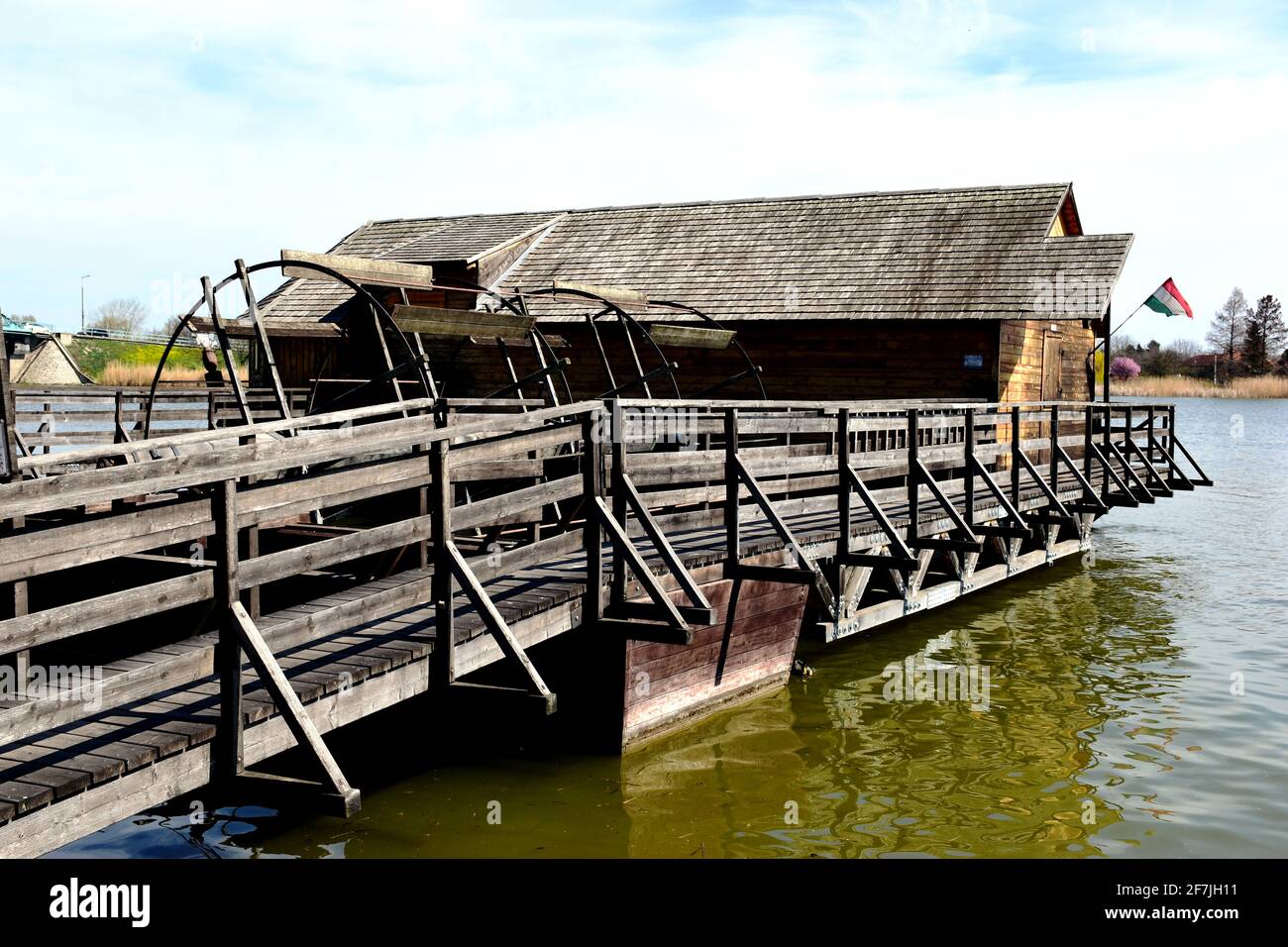 historic wooden floating boat mill. green river water. large boat house ...