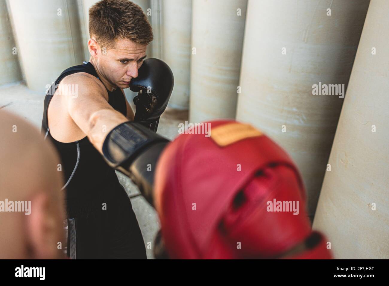Two men exercising and fighting in outside. Boxer in gloves is training ...