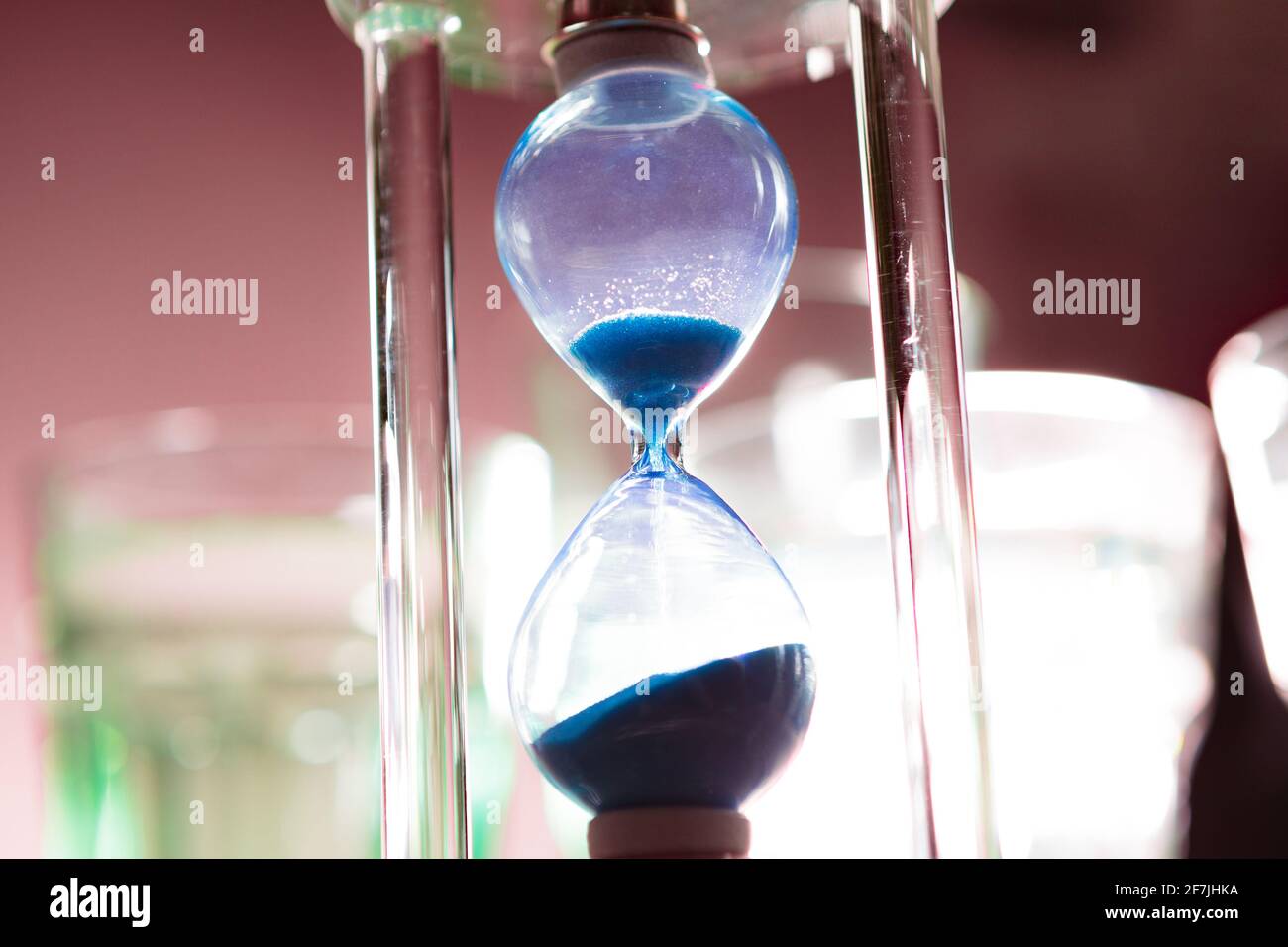 Shiny hourglass on blue background hi-res stock photography and images ...