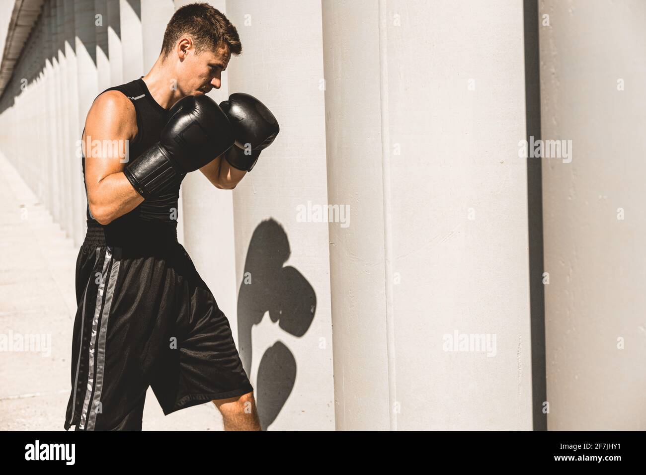 Man exercising and fighting in outside, boxer in gloves. male boxer ...