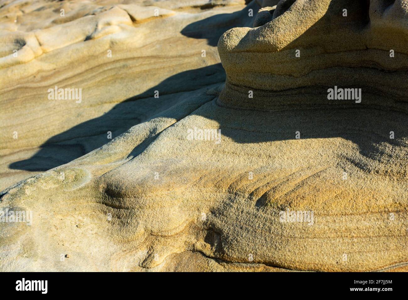 Rock formations of sandstone and other materials on the coast of the ...
