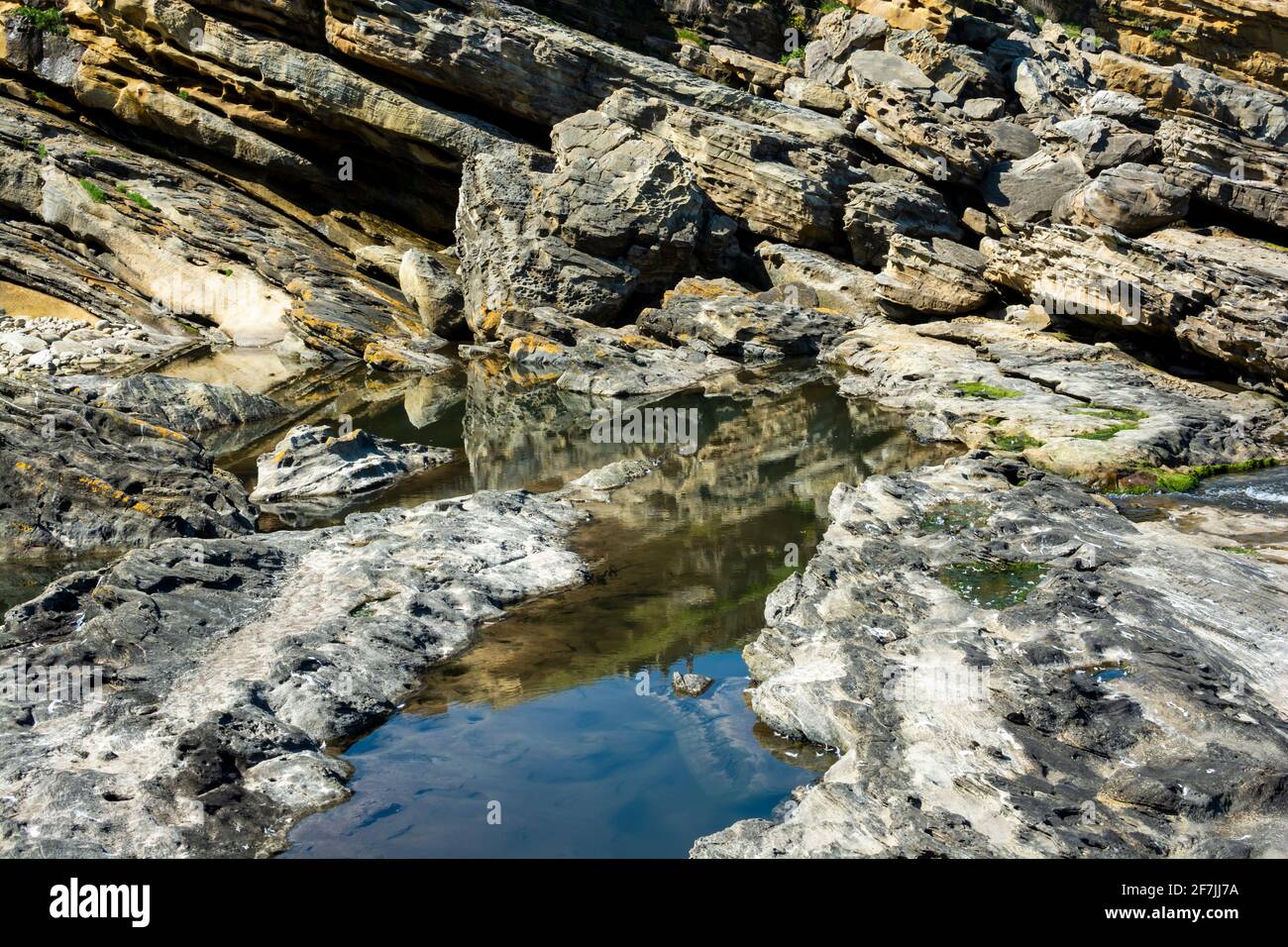 Rock formations of sandstone and other materials on the coast of the ...