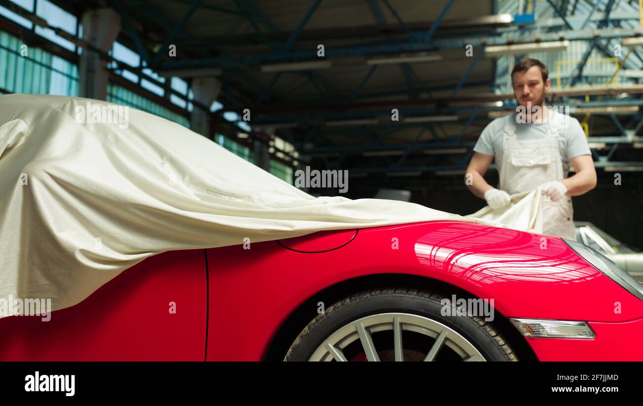 Red classic car unveiling in the garage Stock Photo - Alamy