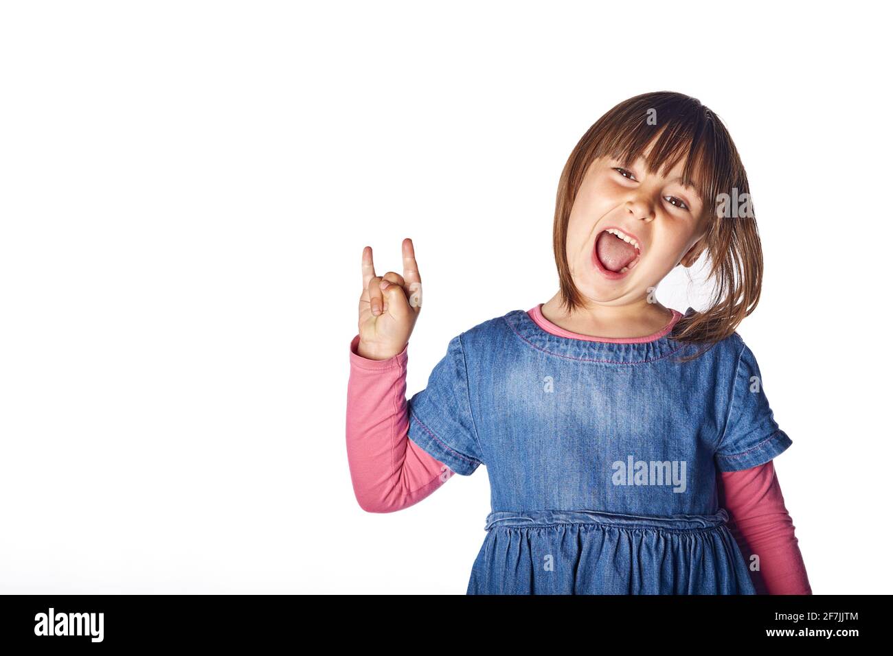 Little girl shows Rock and Roll Hand Signs isolated on white background ...