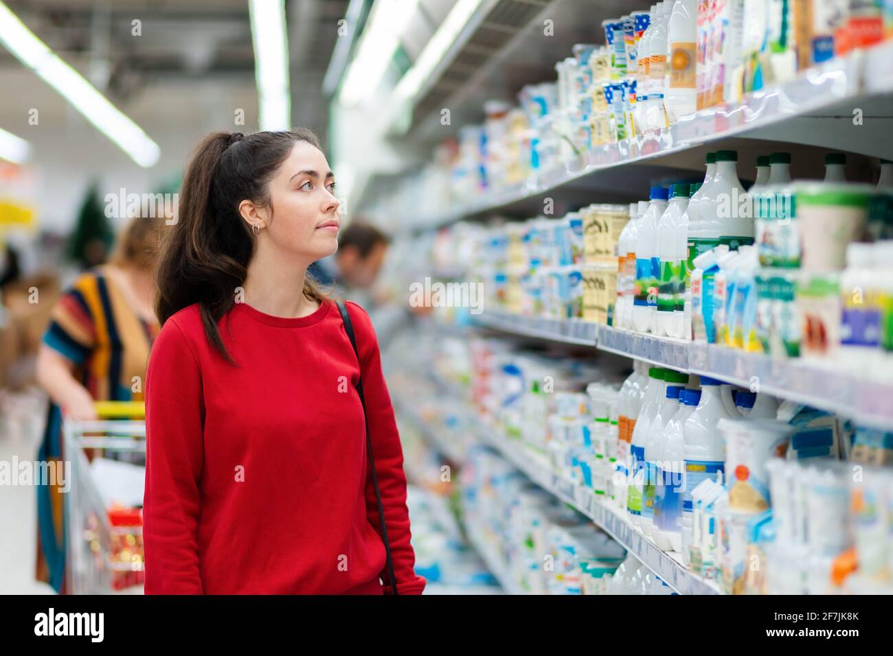 Shopping. Portrait of a young pretty woman looking at the display cases ...