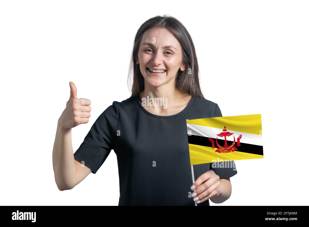 Happy young white woman holding flag of Brunei and shows the class by ...