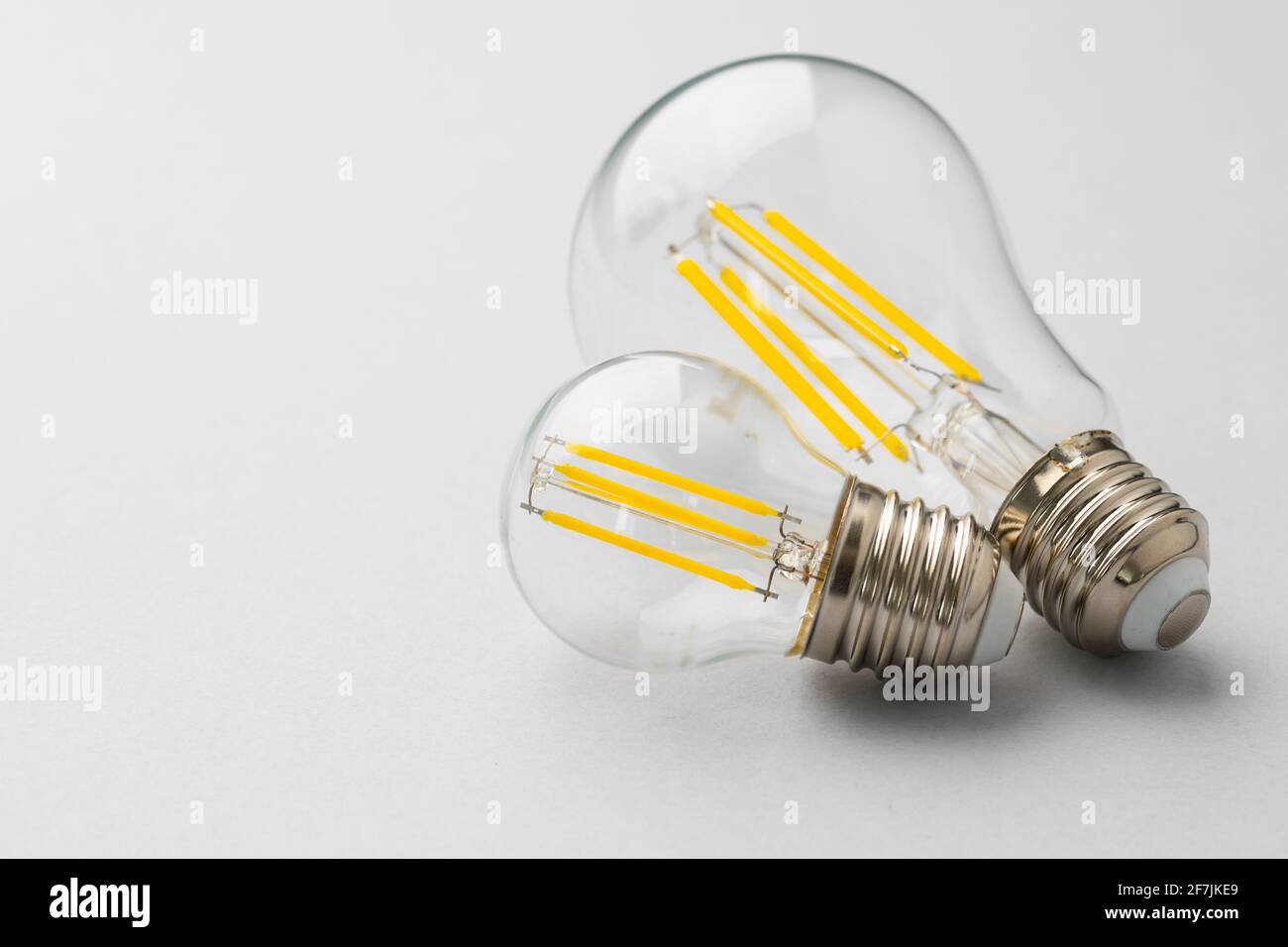 Light bulb on light grey paper background Stock Photo - Alamy