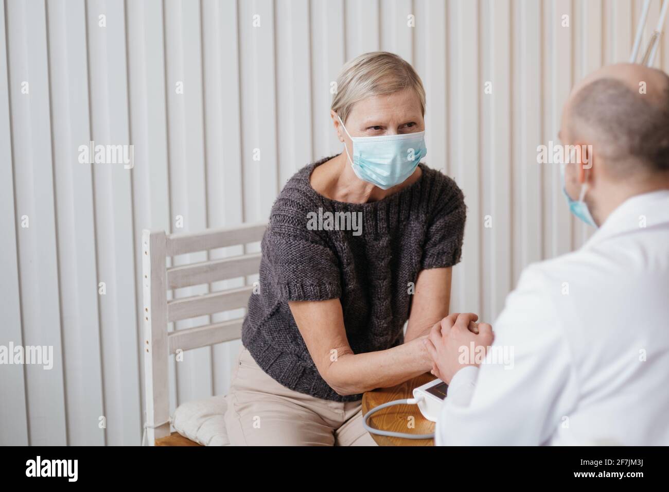 doctor calms the agitated patient during the visit Stock Photo - Alamy