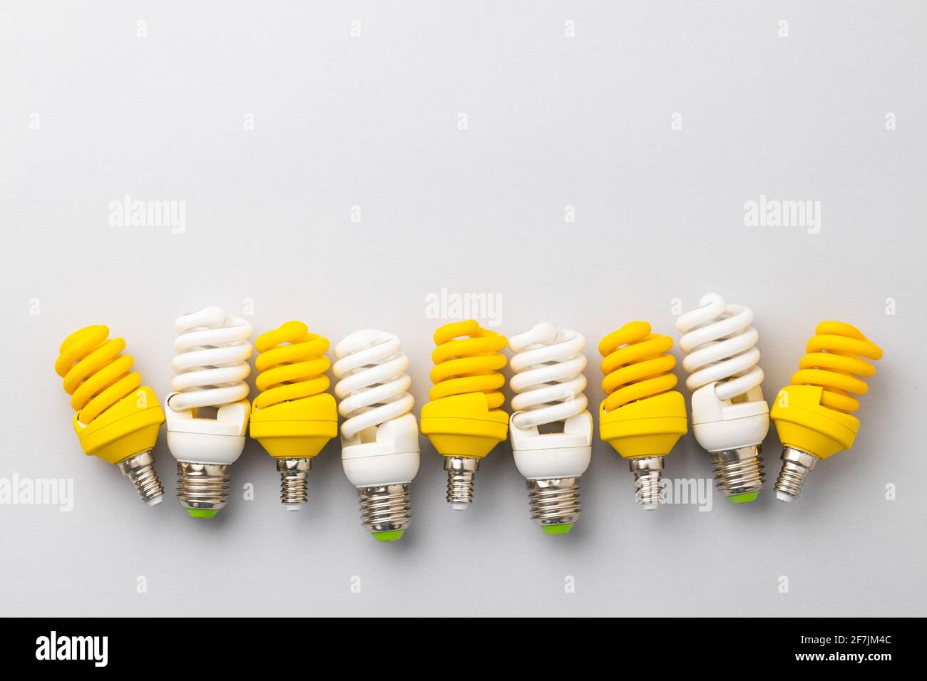 Light bulb on light grey paper background Stock Photo - Alamy