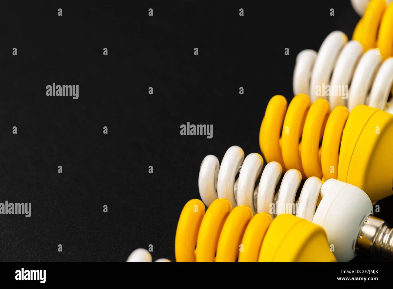 White and yellow light bulbs on black background Stock Photo - Alamy