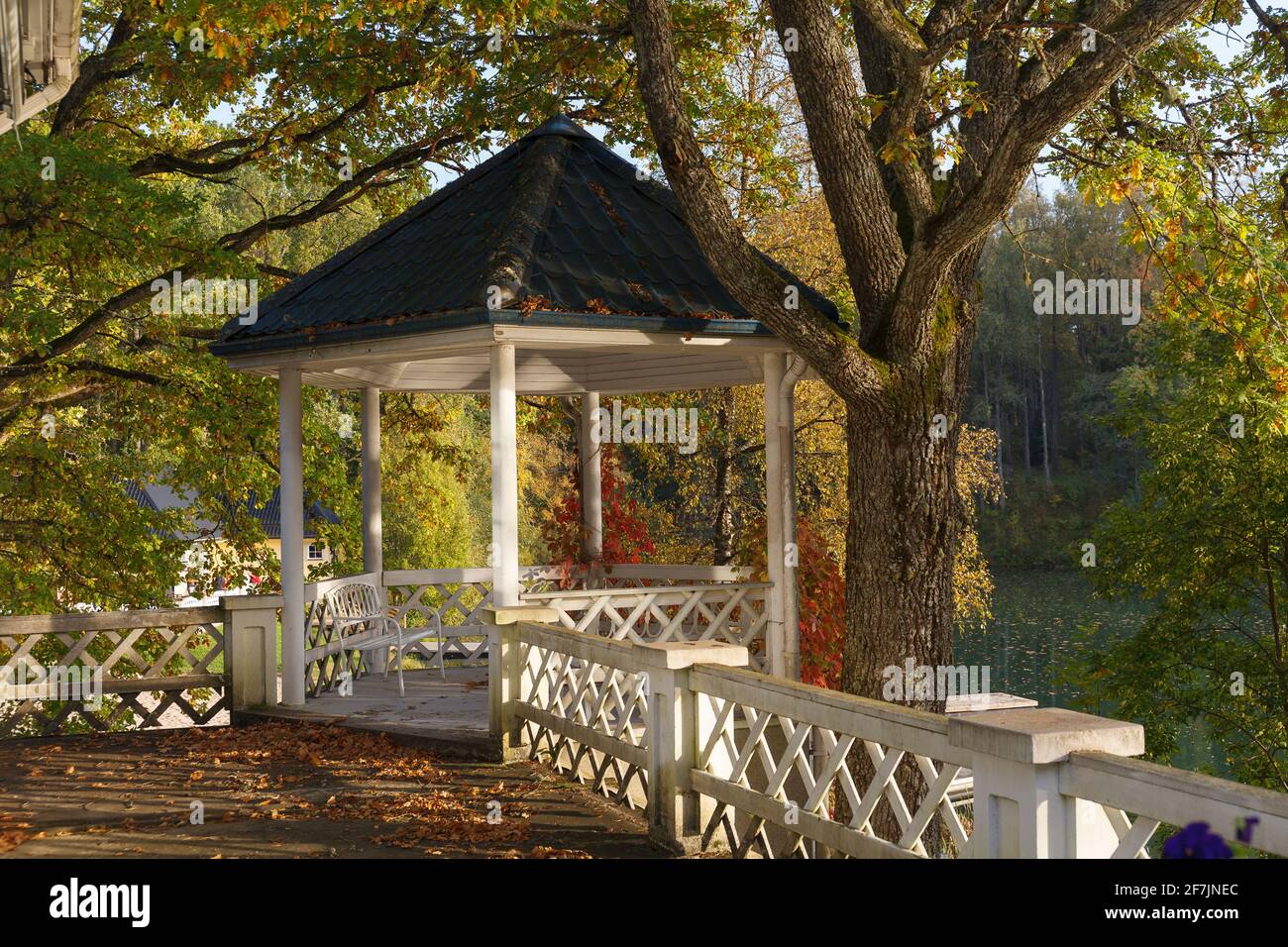 Gazebo with fence at countryside. Wood painted in white Stock Photo - Alamy