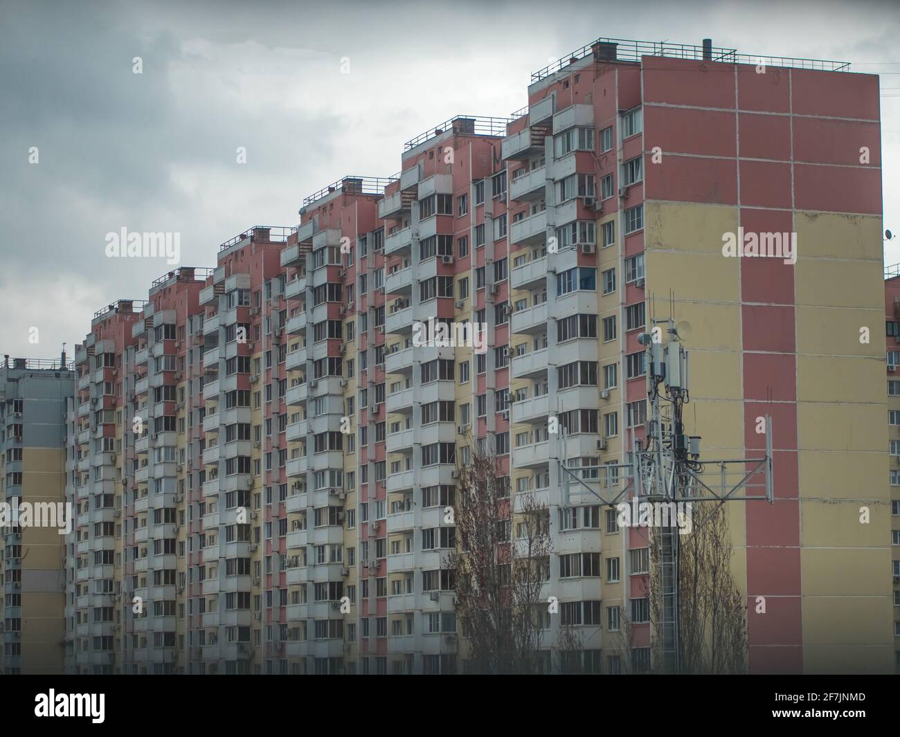 Multi-storey panel house made of reinforced concrete against a gray sky ...