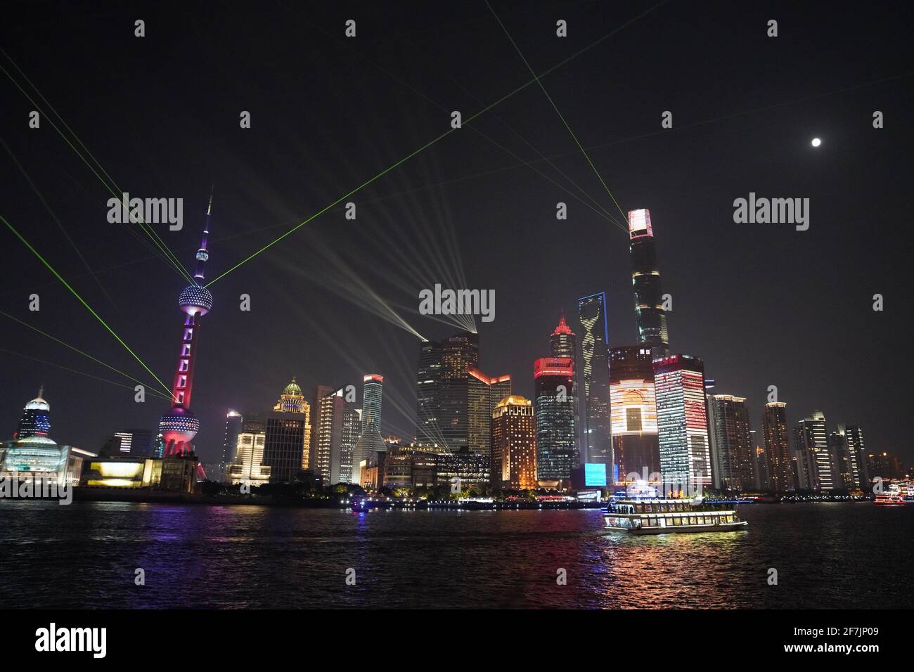 Tall buildings and towers with colourful LED lights on during night in ...