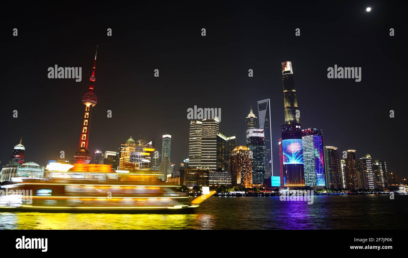 Tall buildings and towers with colourful LED lights on during night in ...