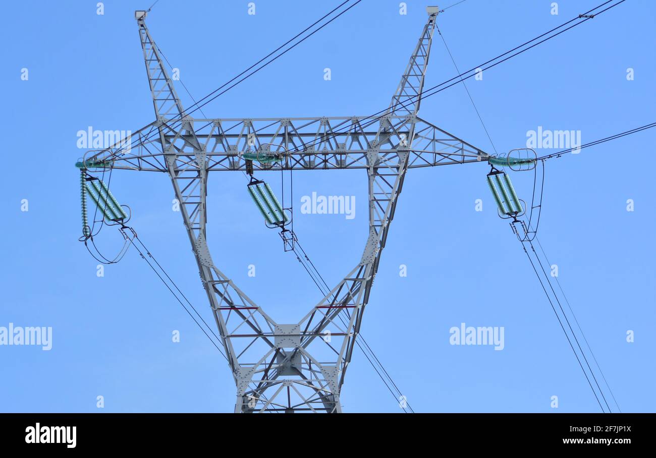 High metal structure with high voltage transmission cables and a blue ...
