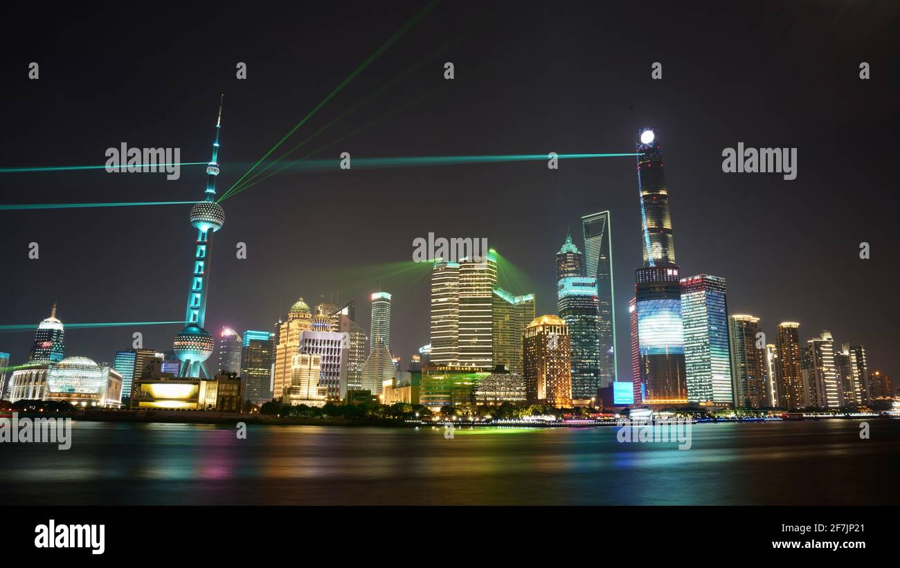 Tall buildings and towers with colourful LED lights on during night in ...