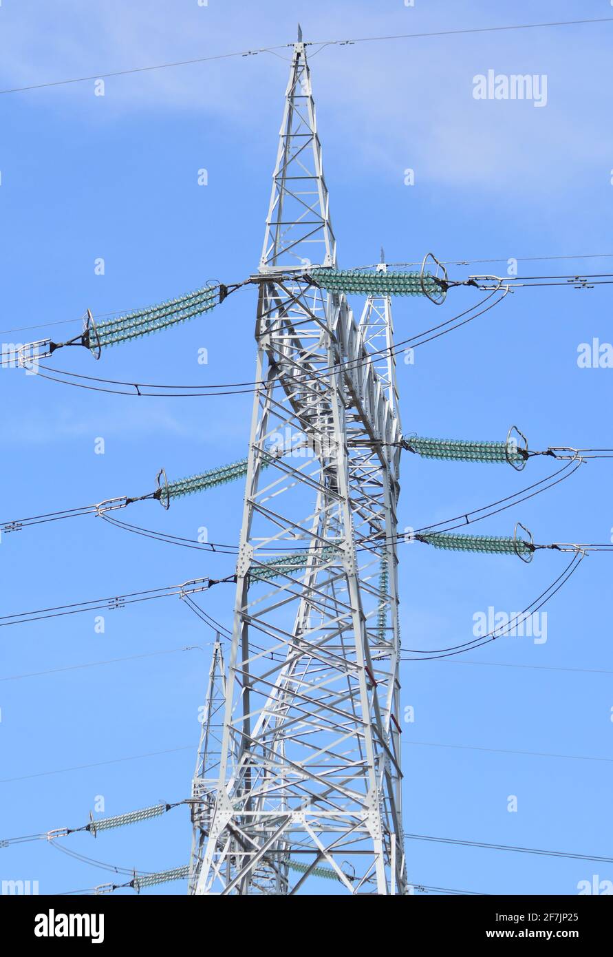 High metal structure with high voltage transmission cables and a blue ...