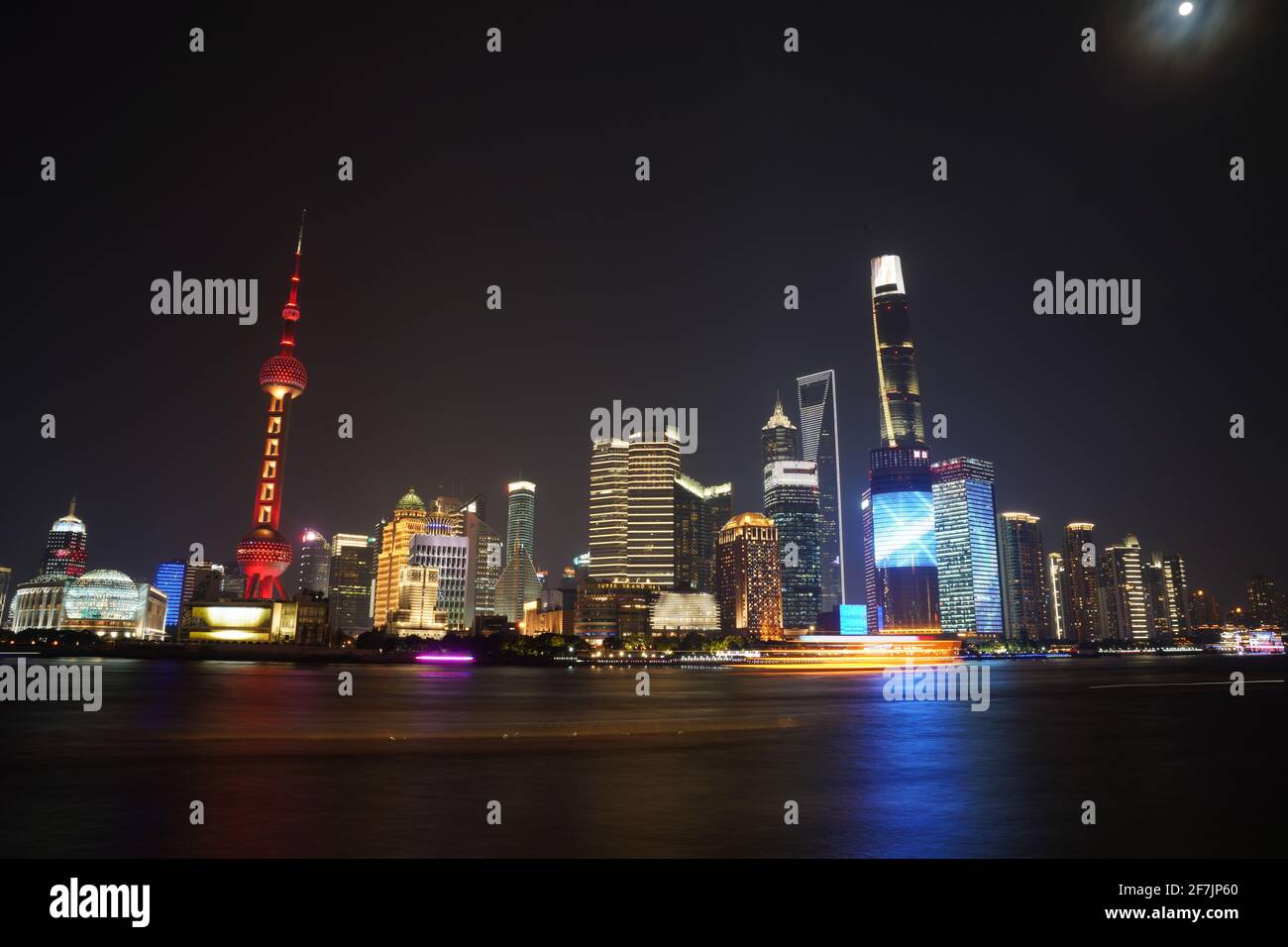 Tall buildings and towers with colourful LED lights on during night in ...