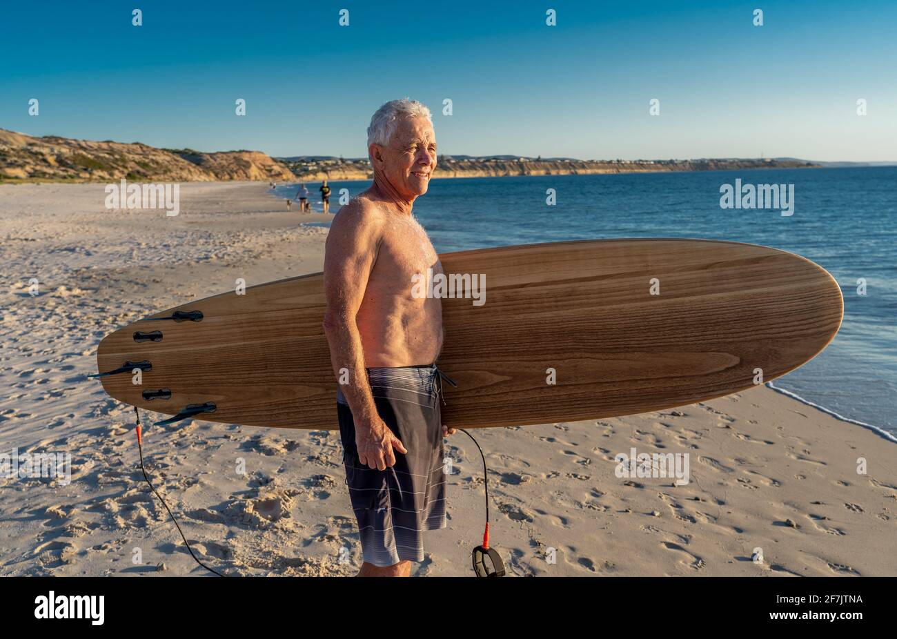 Attractive Australian mature man surfer with cool vintage surfboard on ...