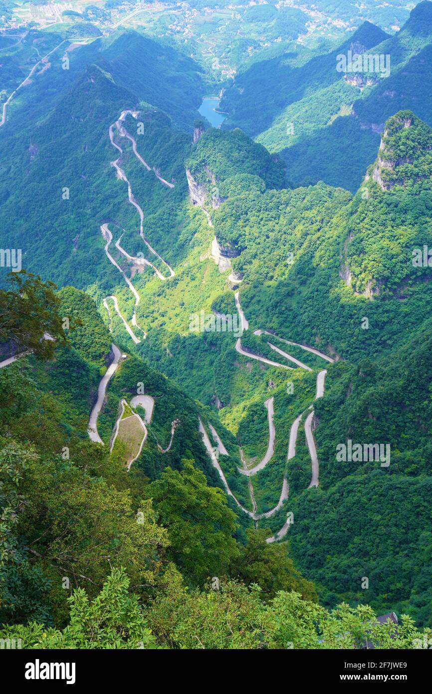 Small mountain roads climb up and down between the green valley in ...