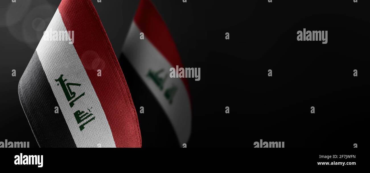 Small national flags of the Iraq on a dark background Stock Photo - Alamy